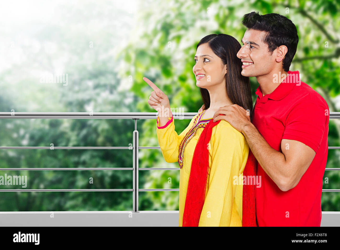 2 indian Married Couple At Home Railing standing finger pointing Stock ...