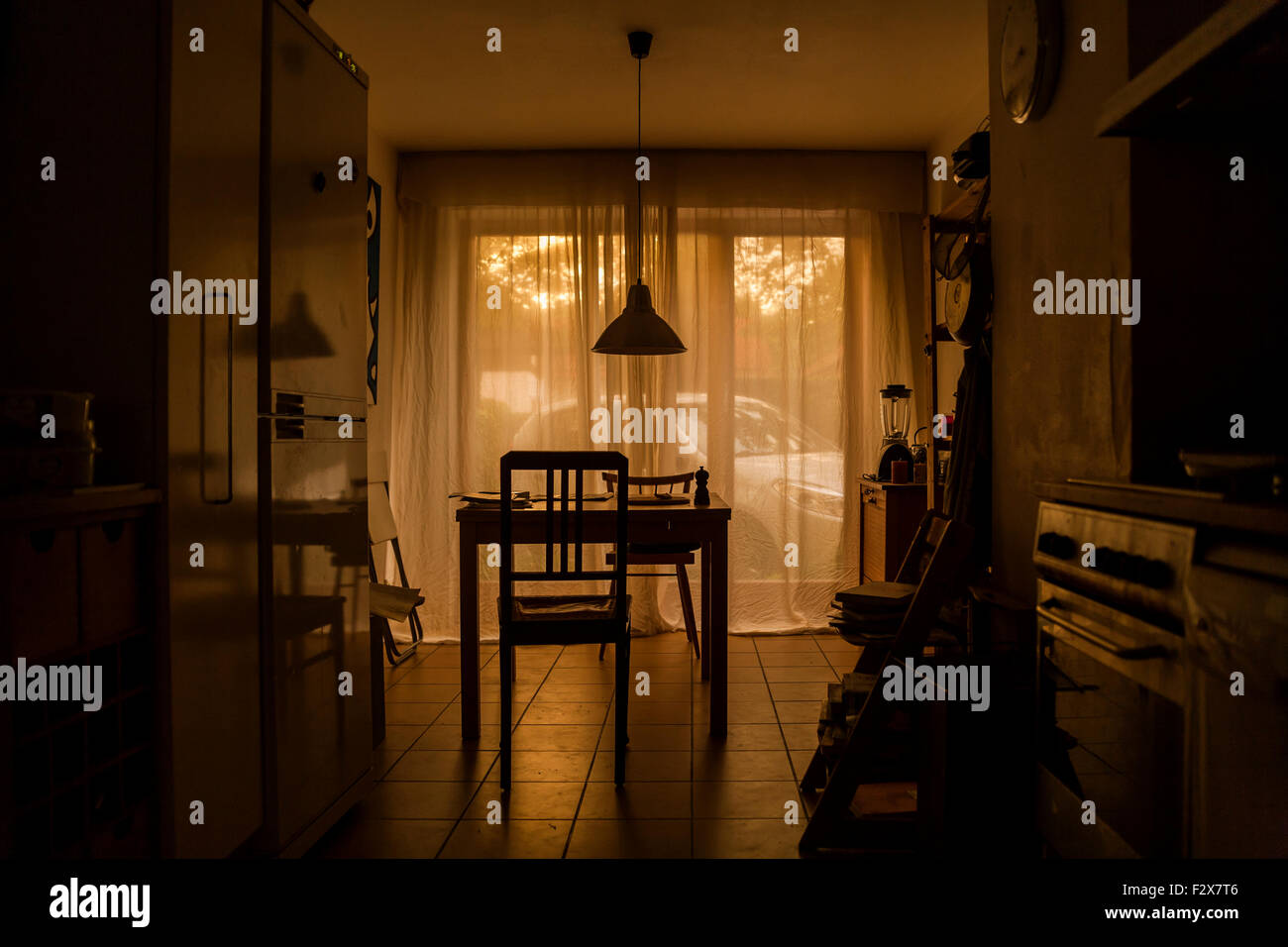 Indoor view of a kitchen at twilight Stock Photo - Alamy