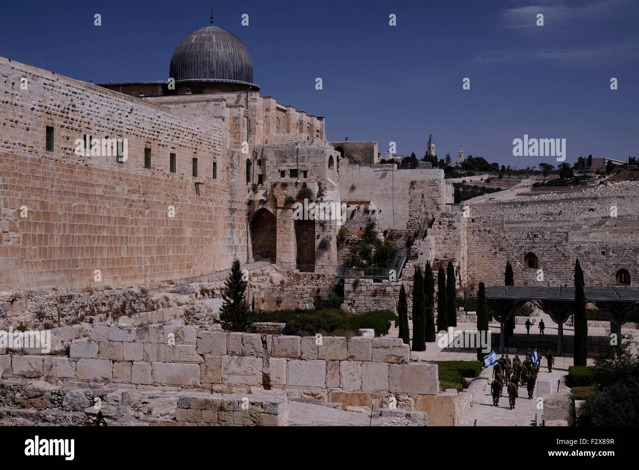 A group of Israeli soldiers stand with Israeli flags maid ruins of ...