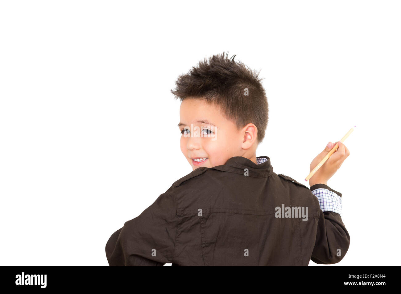 Little boy backwards, looking to camera, drawing in the air, isolated ...