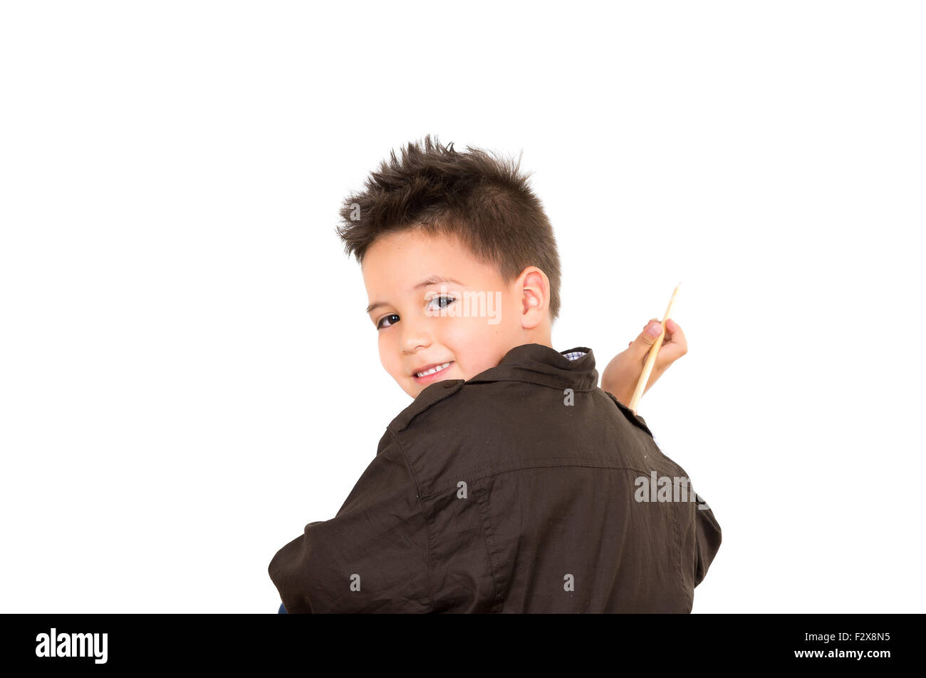 Little boy backwards, looking to camera, drawing in the air, isolated ...