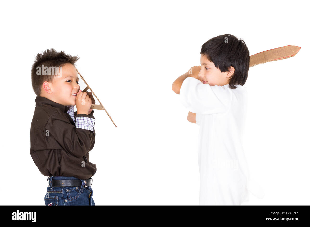 Two small boys simluating sword fight using toys and homemade shield ...