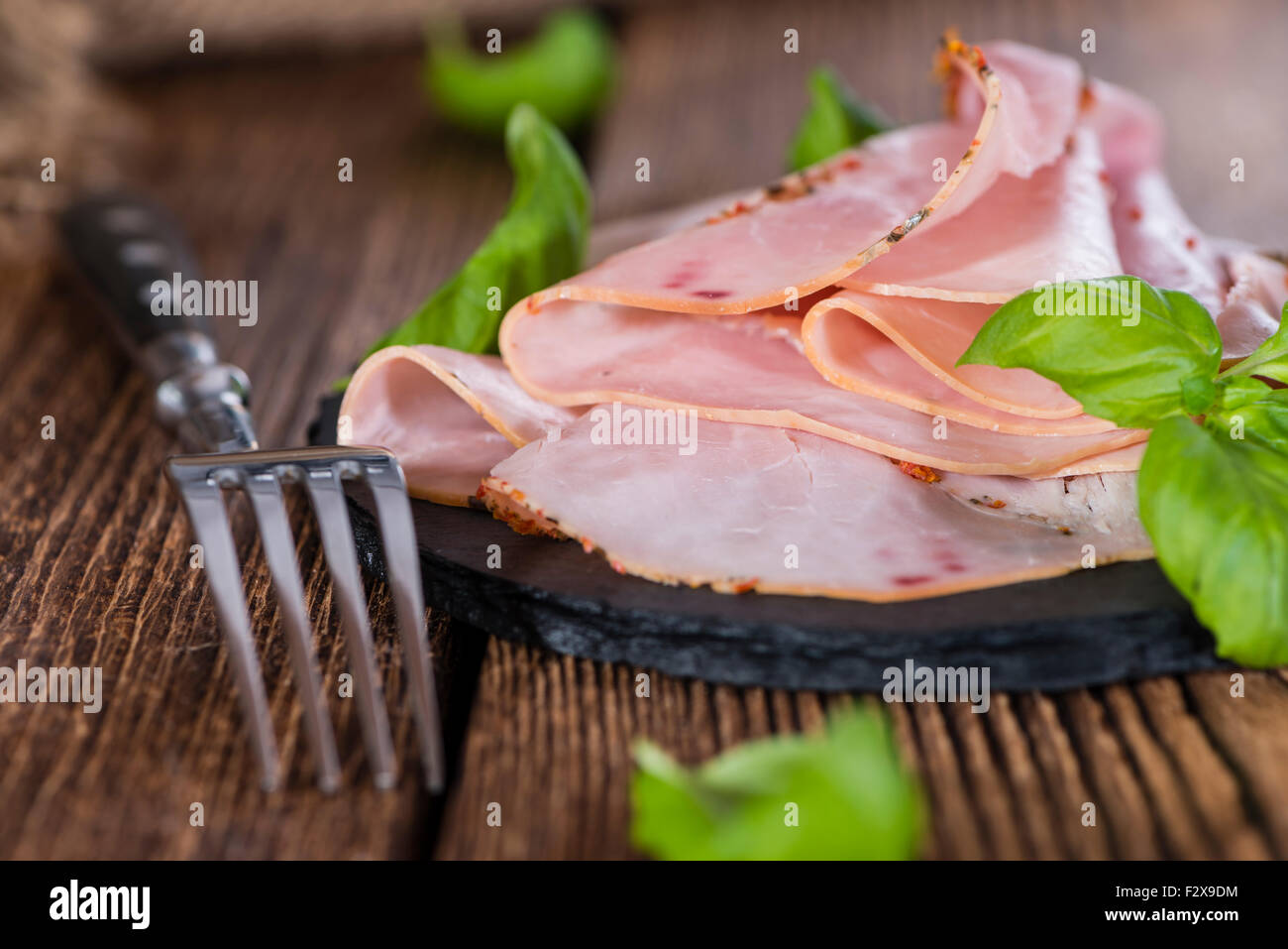 Slices of boiled Ham (close-up shot) with fresh basil Stock Photo - Alamy