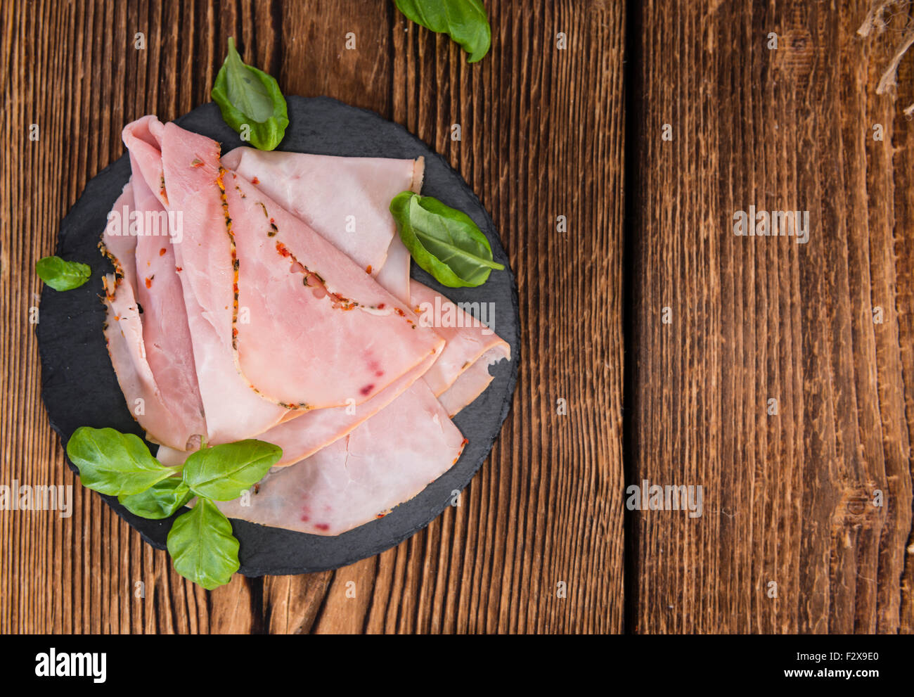 Slices of boiled Ham (close-up shot) with fresh basil Stock Photo - Alamy