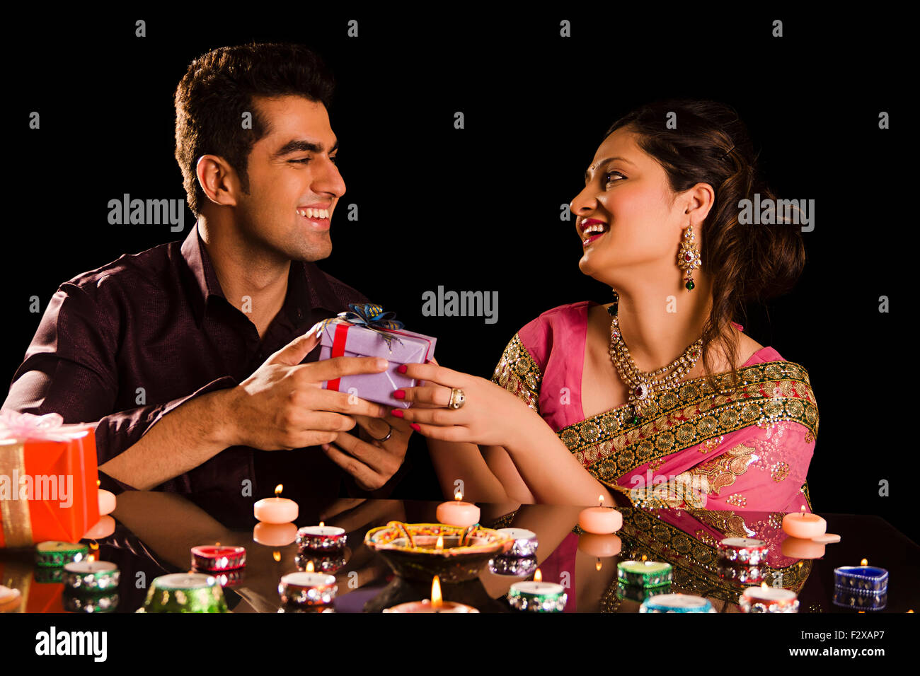 2 indian Married Couple Diwali Festival Diya and Giving gift Stock ...