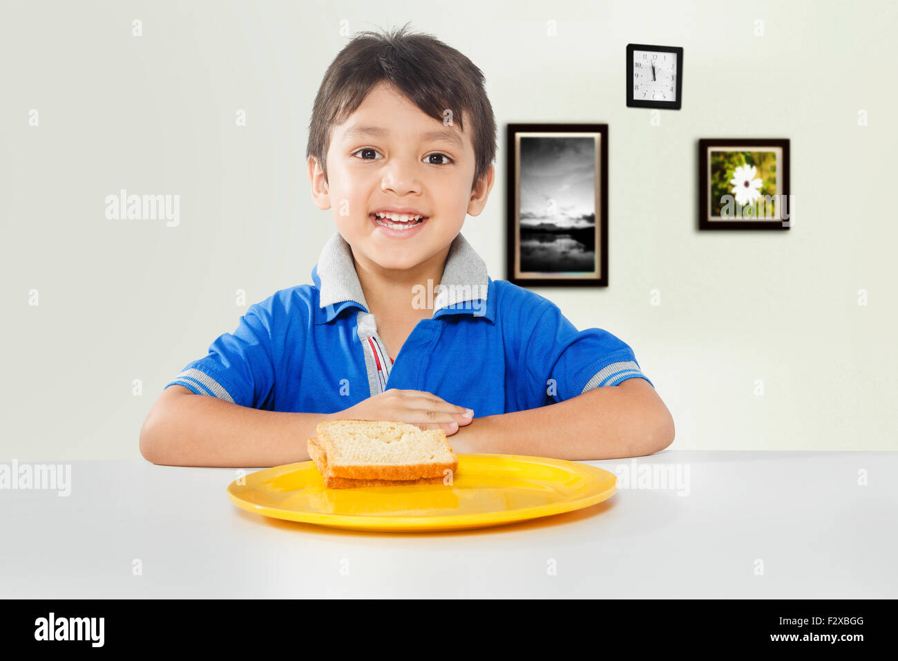 1 indian kid boy eating Bread morning Breakfast Stock Photo - Alamy