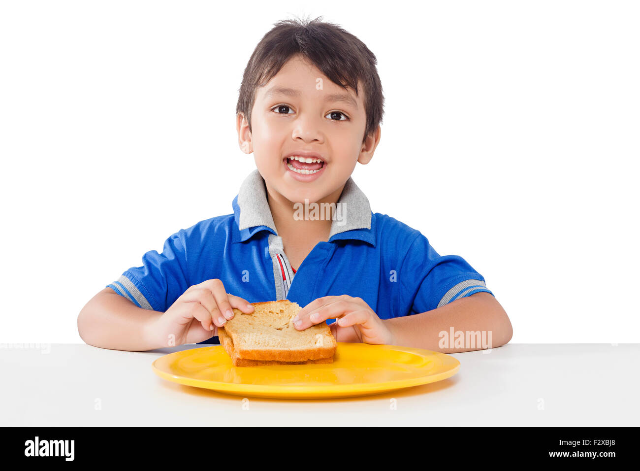 1 indian kid boy Breakfast eating Bread Stock Photo - Alamy