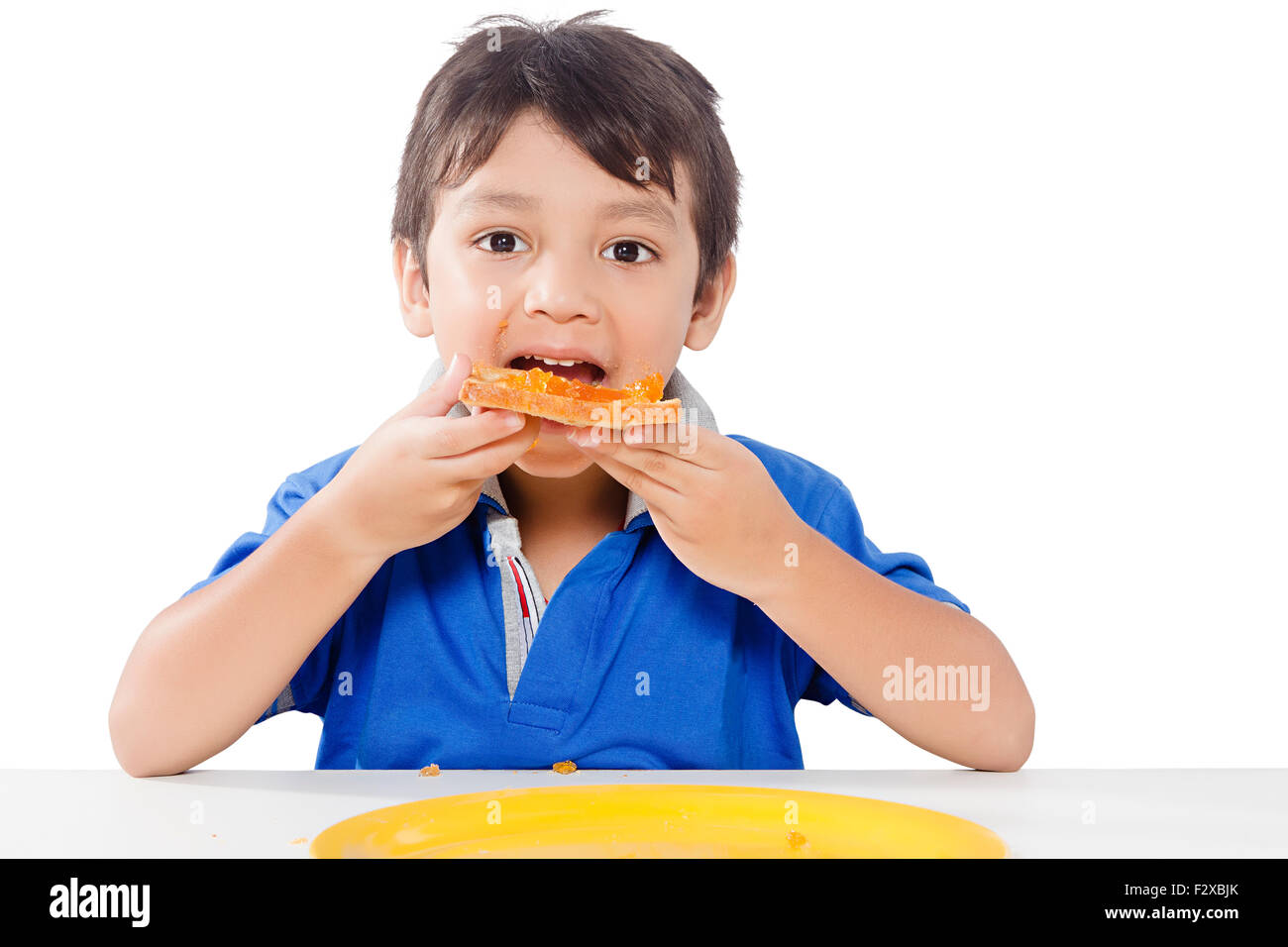 1 indian kid boy Breakfast eating Bread Stock Photo - Alamy