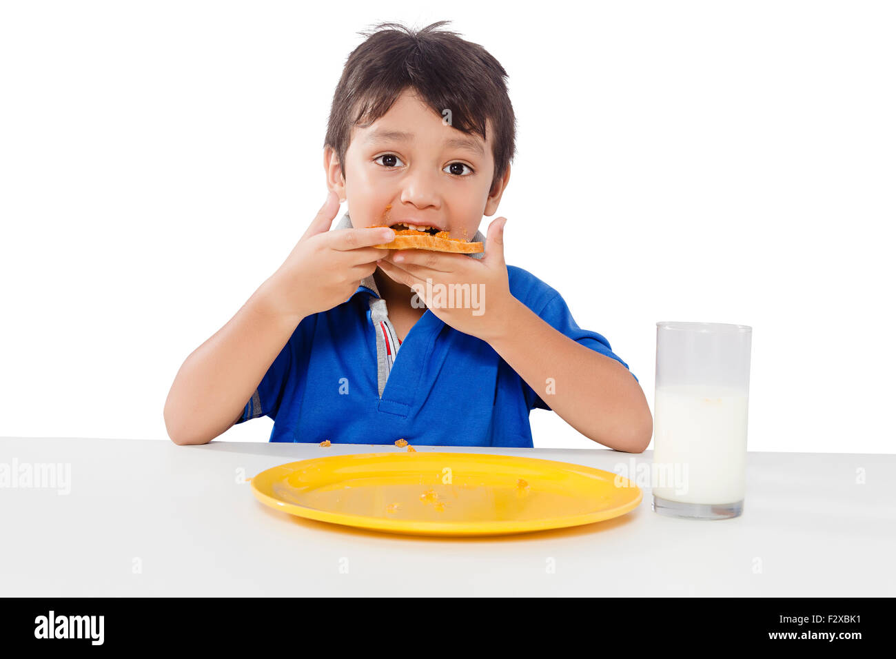 1 indian kid boy Breakfast eating Bread Stock Photo - Alamy
