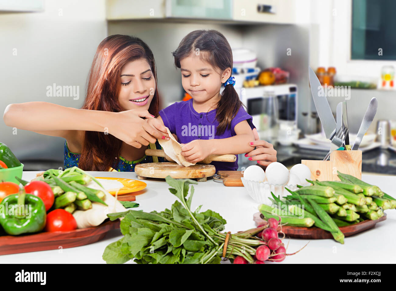 2 indian Mother and kid daughter Kitchen Cooking Stock Photo - Alamy