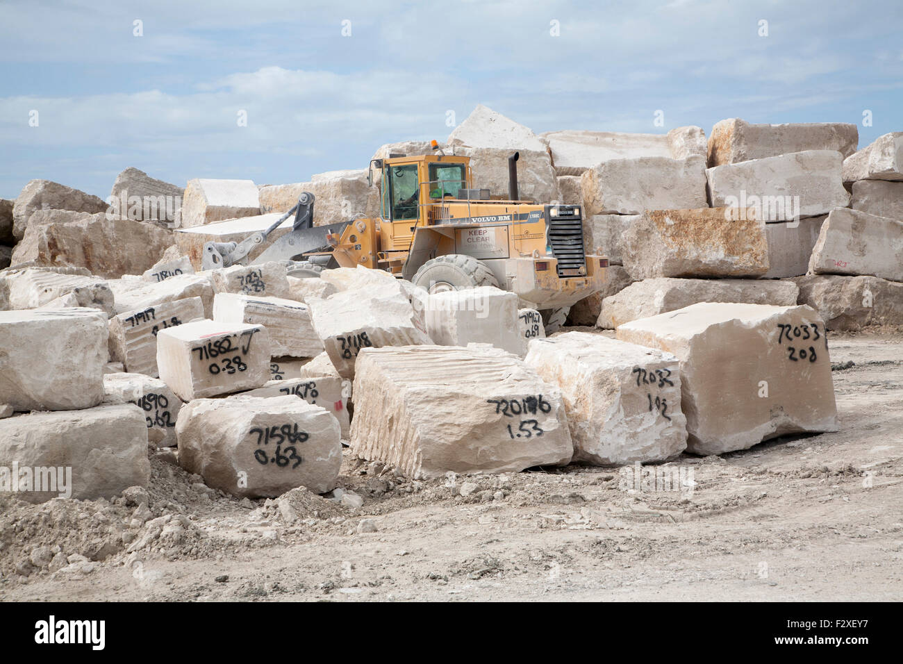 Heavy machinery at work in a stone quarry on the Isle of Portland ...