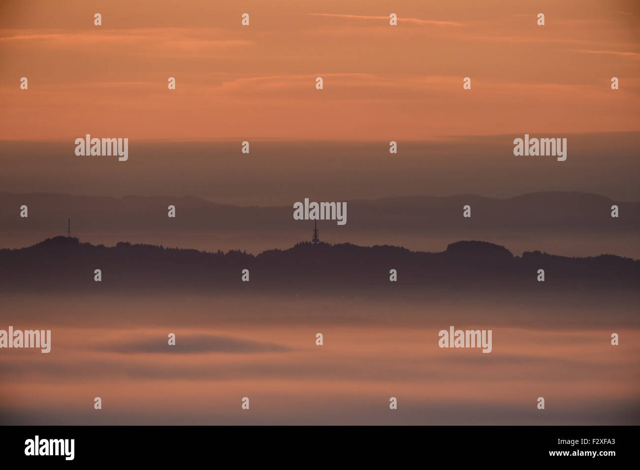 View of the Upper Swabian region shrouded in thick fog at sunrise ...