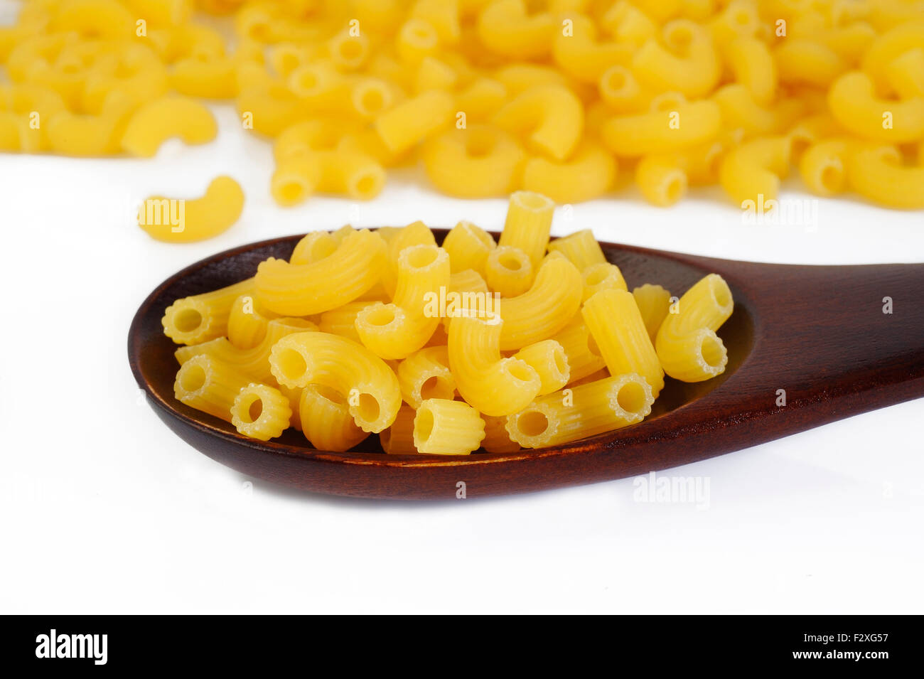 raw pasta macaroni in wooden spoon Stock Photo - Alamy