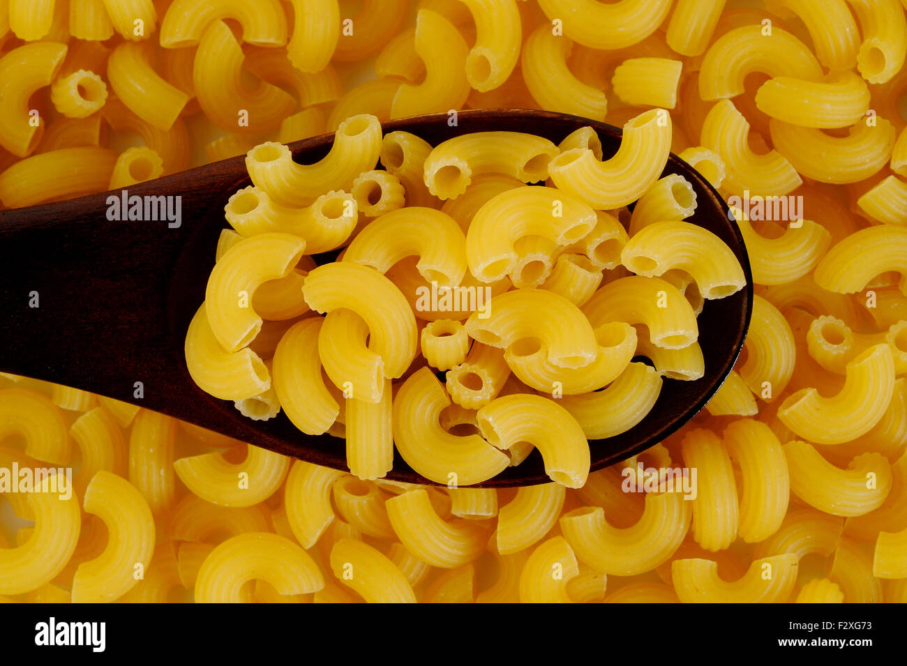 raw pasta macaroni in wooden spoon Stock Photo - Alamy