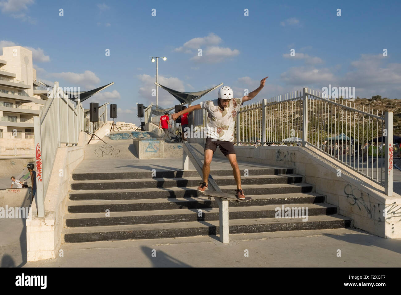 Urban extreme sport park. Young skateboarder performs stunts with a ...