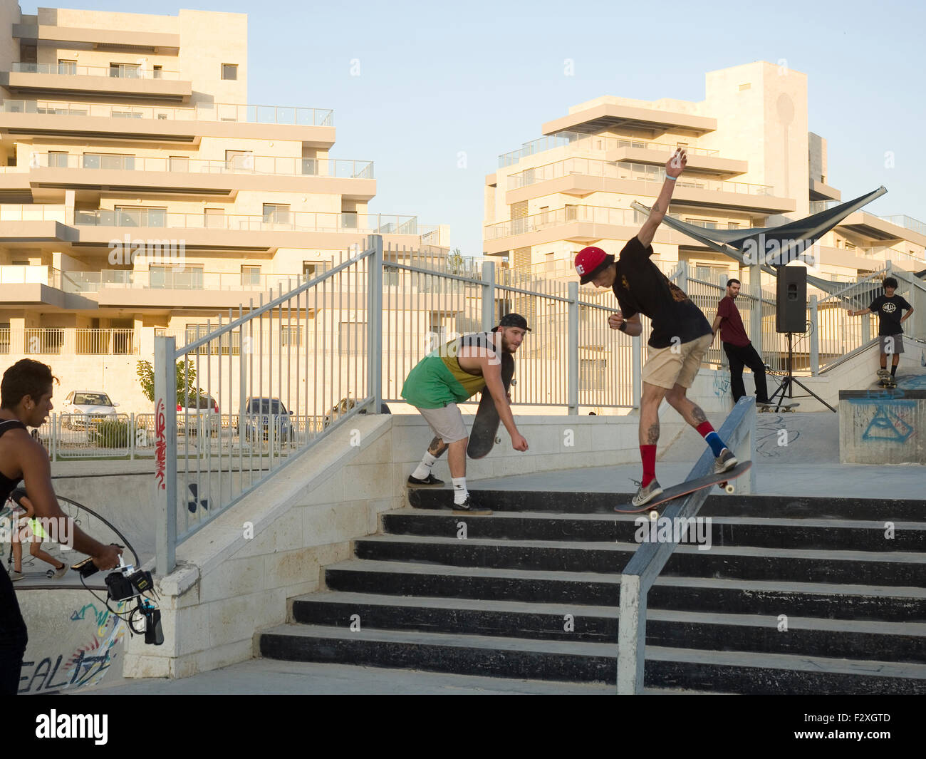 Urban extreme sport park. Young skateboarder performs stunts with a ...