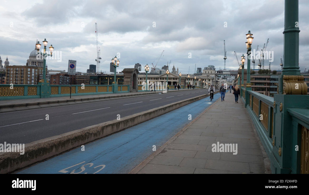 Southwark Bridge with lights, London with construction cranes in ...