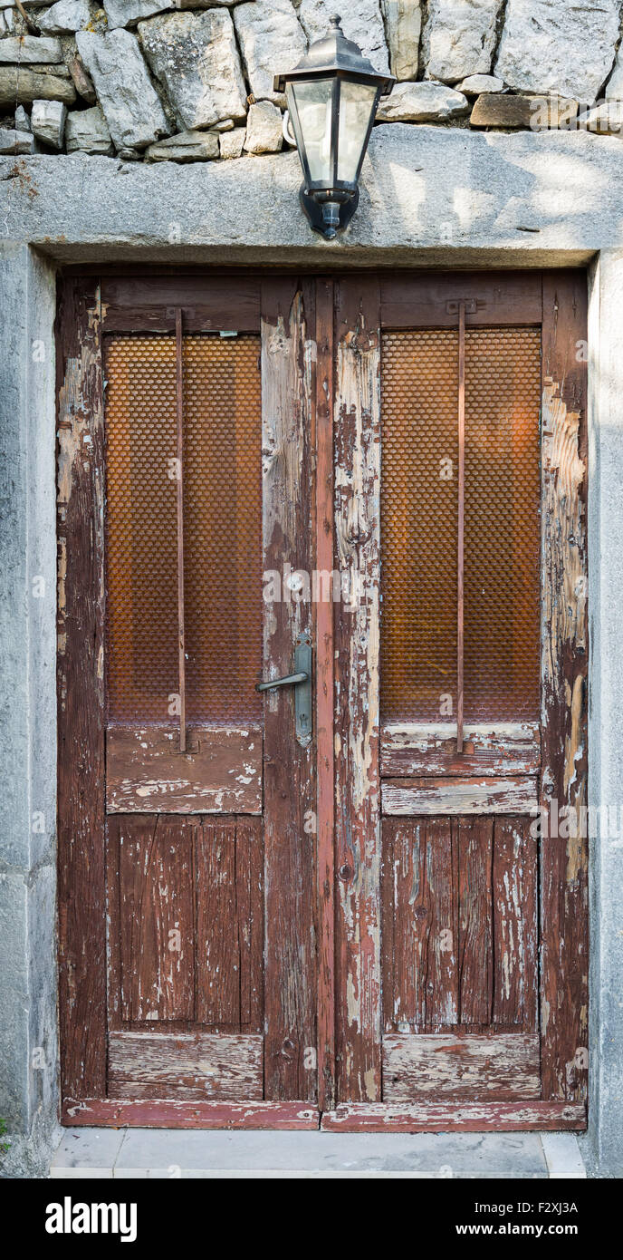 an old brown yellow ragged shabby wooden door Stock Photo - Alamy