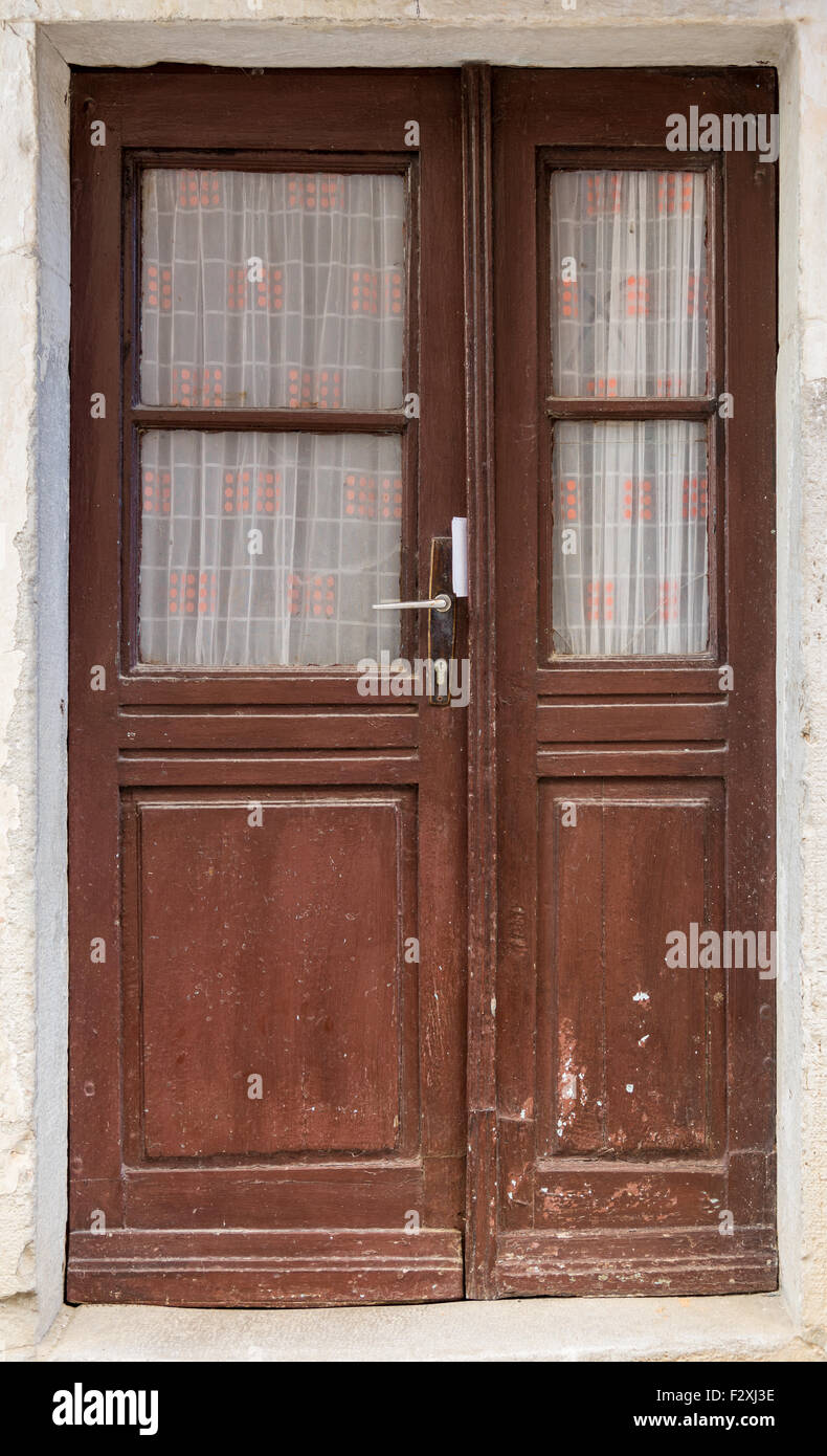 an old brown yellow ragged shabby wooden door Stock Photo - Alamy