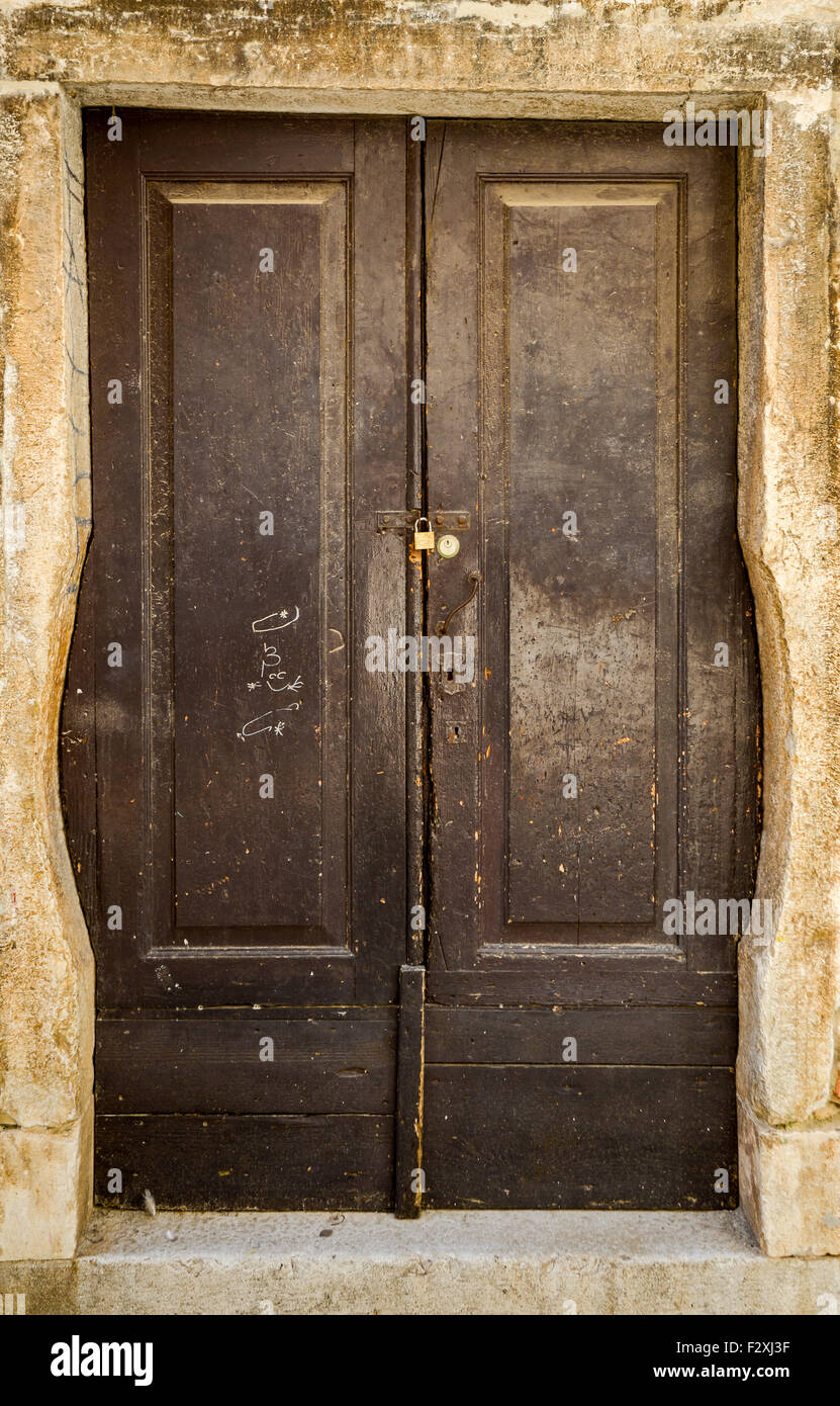 an old brown yellow ragged shabby wooden door Stock Photo - Alamy