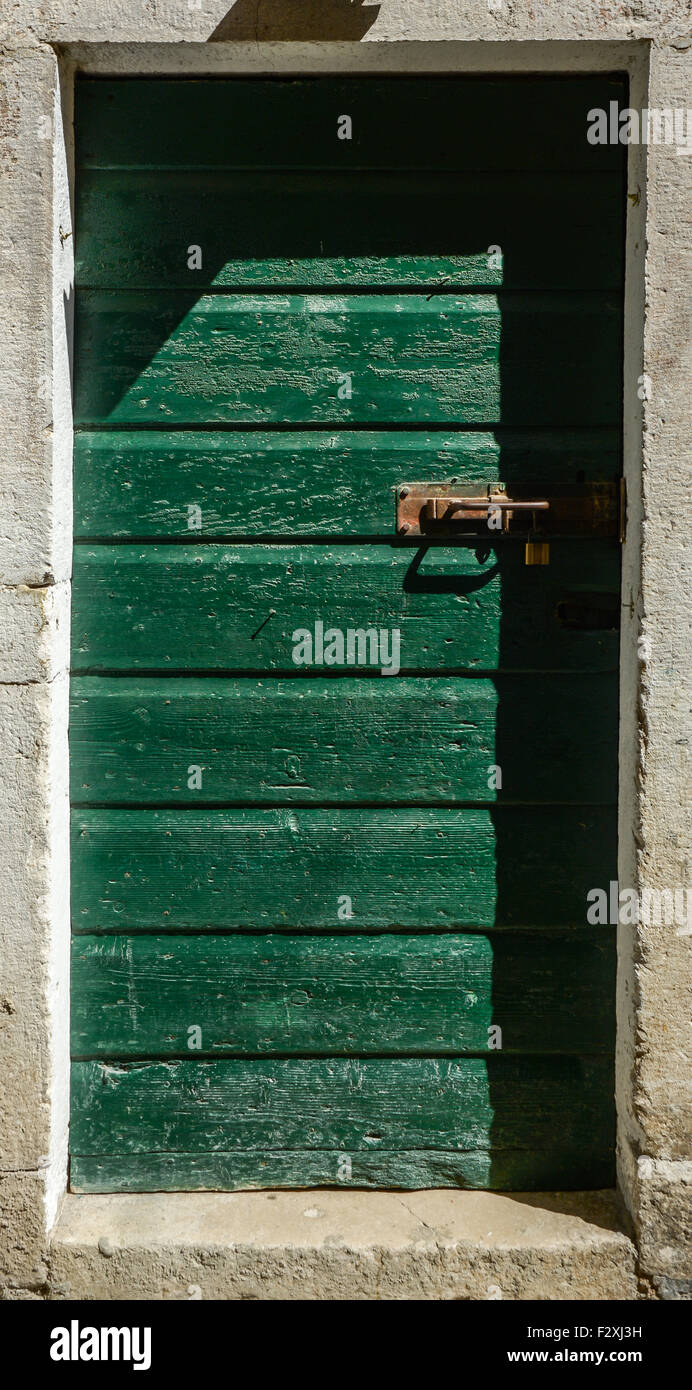 an old green ragged shabby wooden door Stock Photo - Alamy