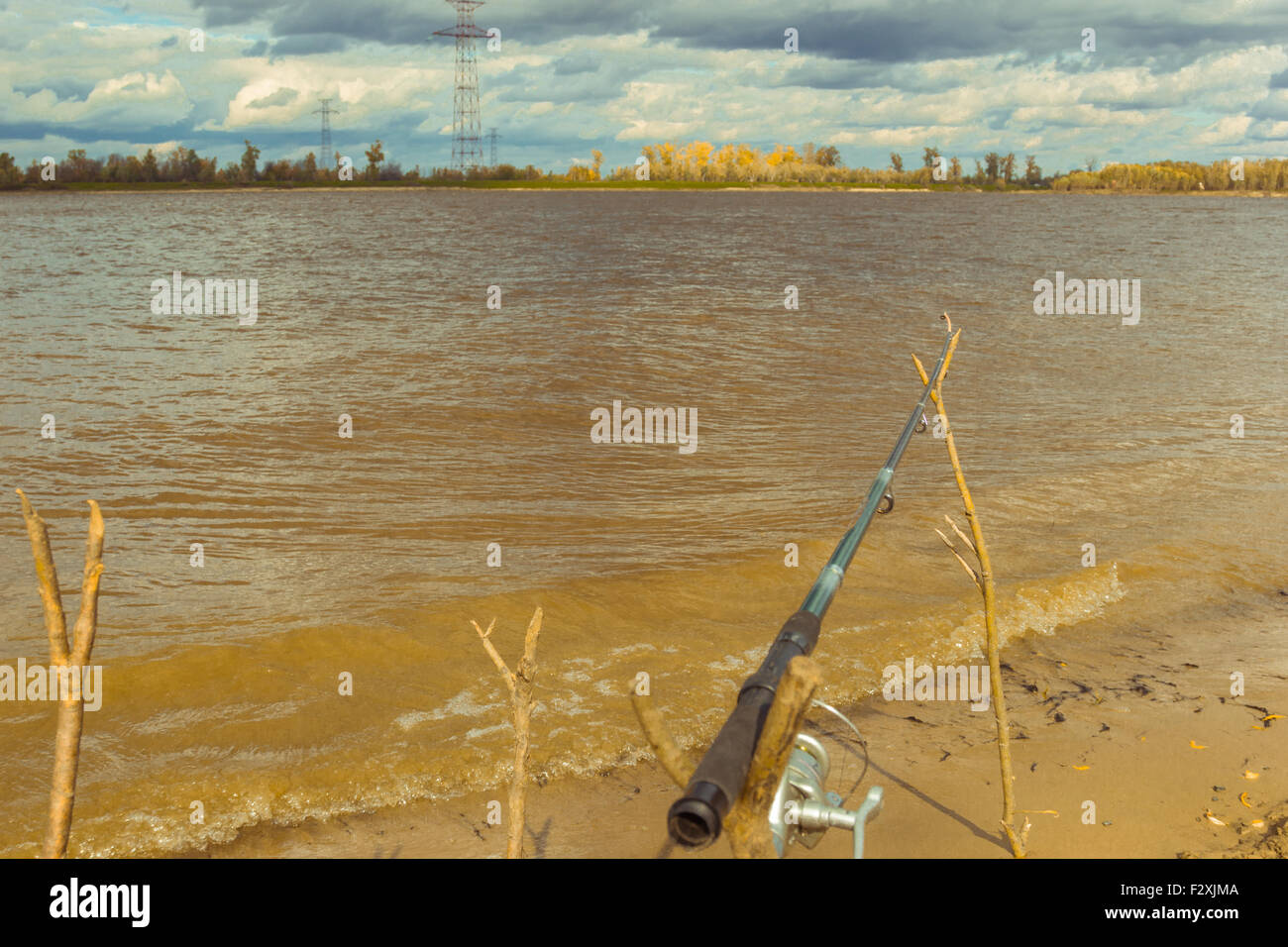 Spinning mounted on wooden Raguli on the river bank Stock Photo - Alamy