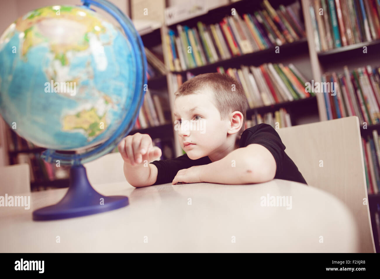 A portrait of boy educating with globe in the classroom scenery Stock ...