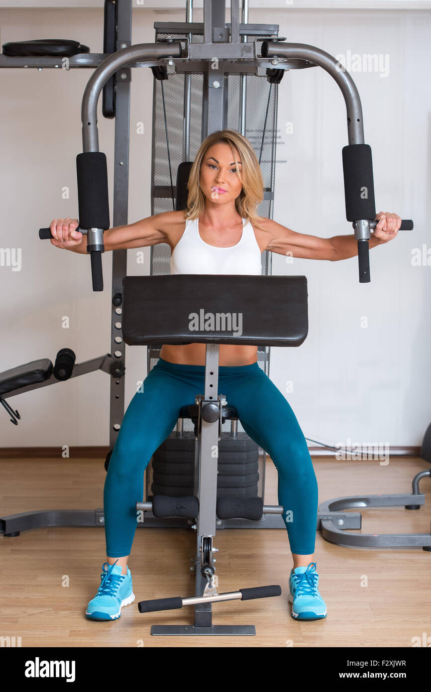 Beautiful girl in sports club on simulator Stock Photo - Alamy
