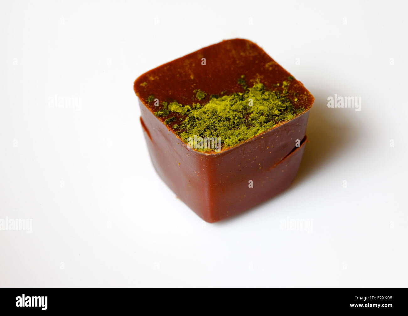 Chocolate candy with pistachio sprinkles isolated on white background ...