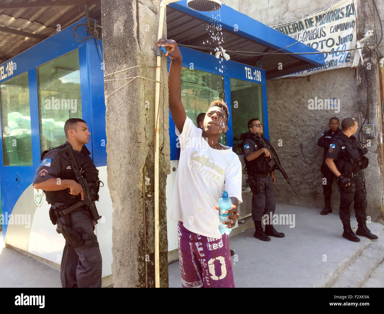 Rio de Janeiro, Brazil. 29th Aug, 2015. Police officers look on as a ...