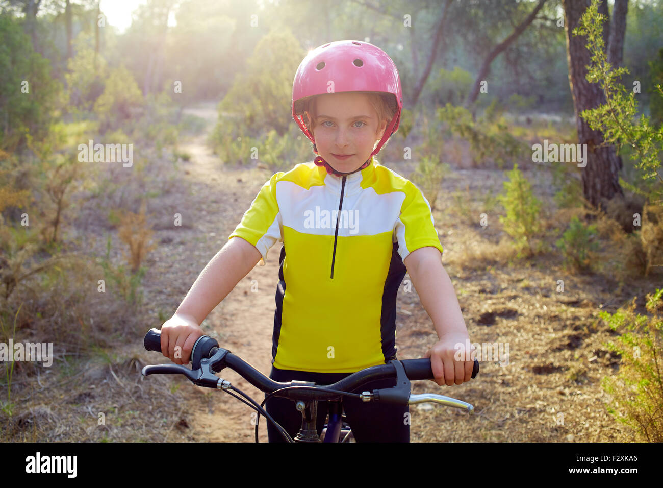 kid girl biker in mountain bike MTB at mediterranean forest Stock Photo ...