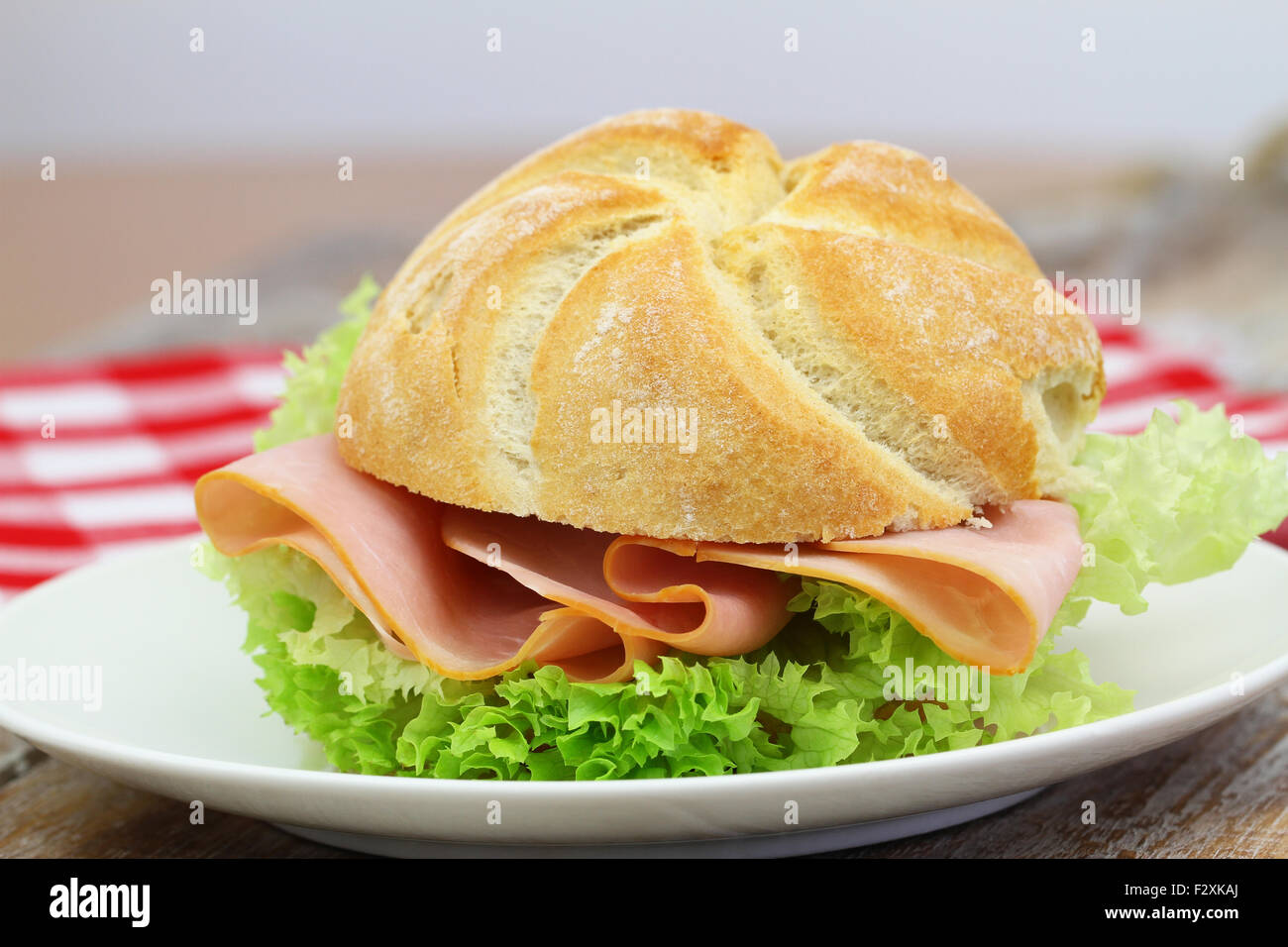Freshly backed ham roll with lettuce, closeup Stock Photo - Alamy