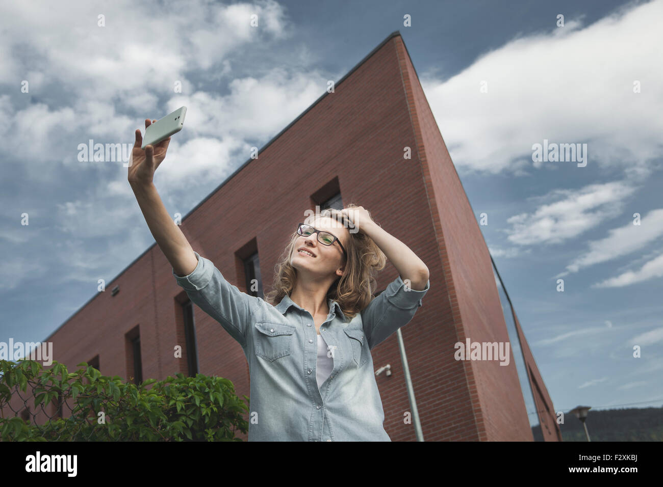 Portrait of female student outside library next to the brick wall Stock ...