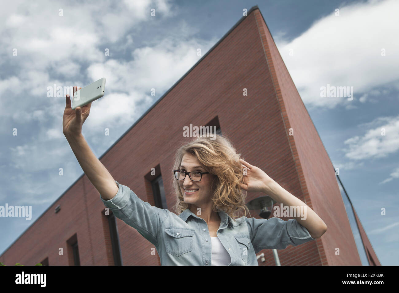 Portrait of female student outside library next to the brick wall Stock ...