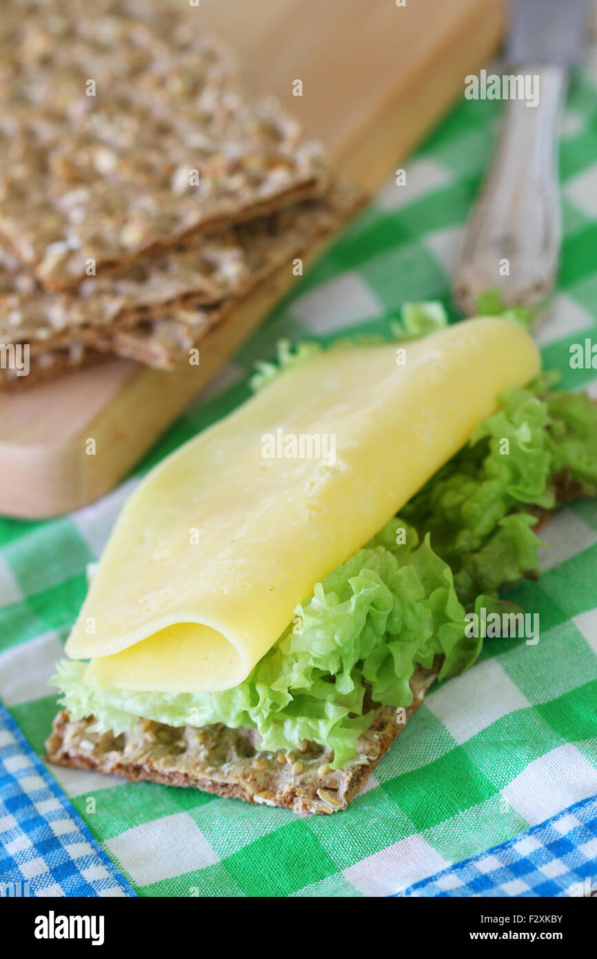 Crisp bread with cheese and lettuce Stock Photo - Alamy