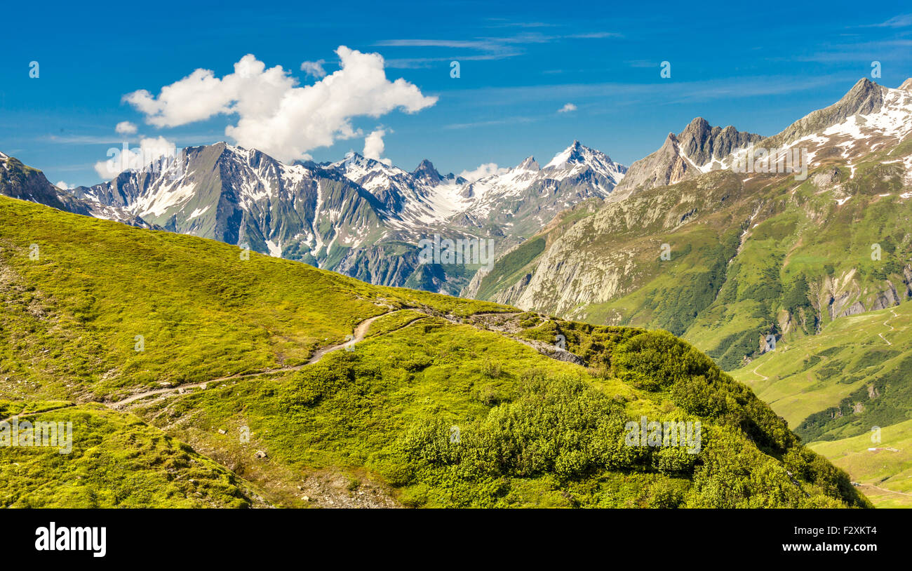 Mountain scenery in the Alps, with a hiking trail in the foreground ...