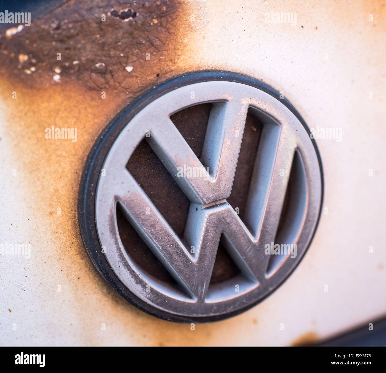 The corporate logo of Volkswagen on a rusty Volkswagen Golf in front of ...