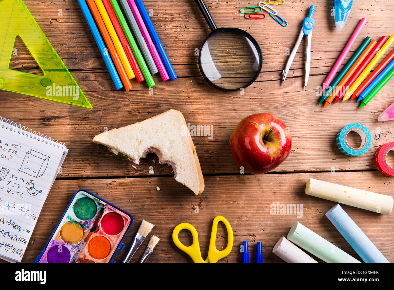 Desk with school supplies. Studio shot on wooden background Stock Photo ...