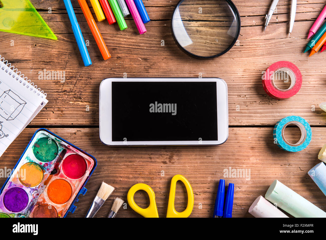 Desk with school supplies. Studio shot on wooden background Stock Photo ...