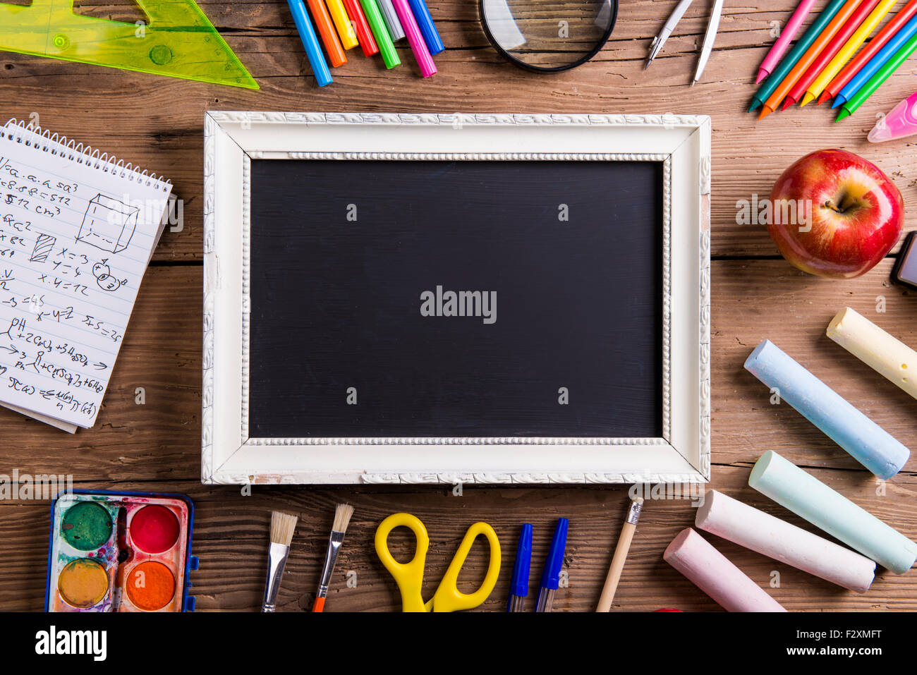 Desk with school supplies. Studio shot on wooden background Stock Photo ...