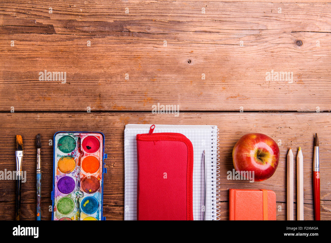 Desk with school supplies. Studio shot on wooden background Stock Photo ...
