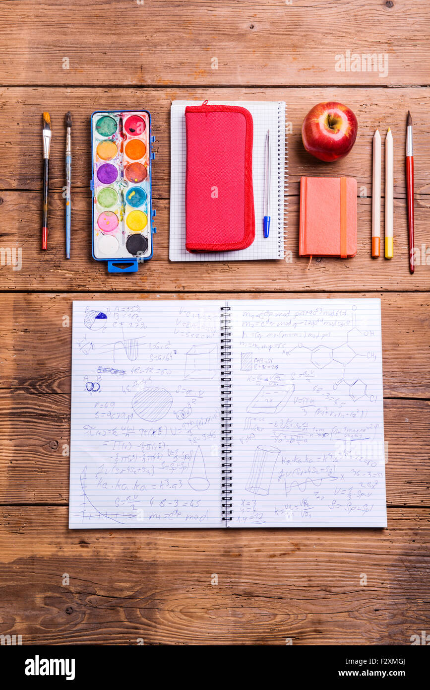 Desk with school supplies. Studio shot on wooden background Stock Photo ...