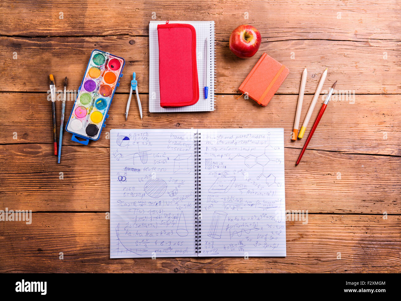 Desk with school supplies. Studio shot on wooden background Stock Photo ...