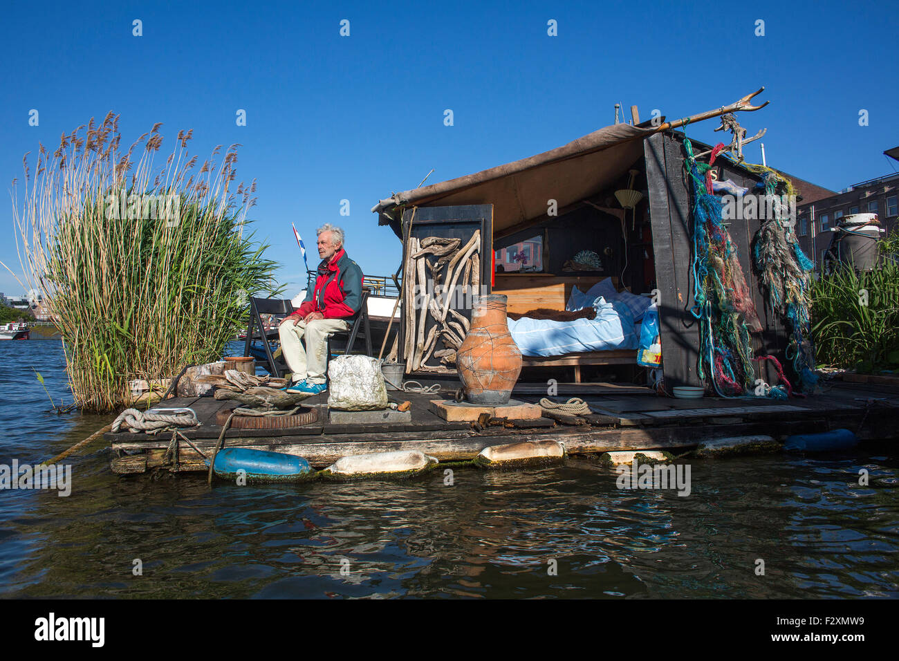 self built rafts in the canals of Amsterdam Stock Photo - Alamy