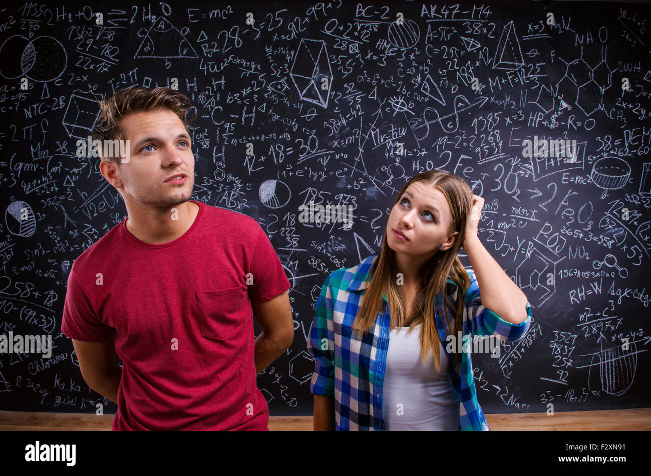 Beautiful young students in front of big blackboard Stock Photo - Alamy