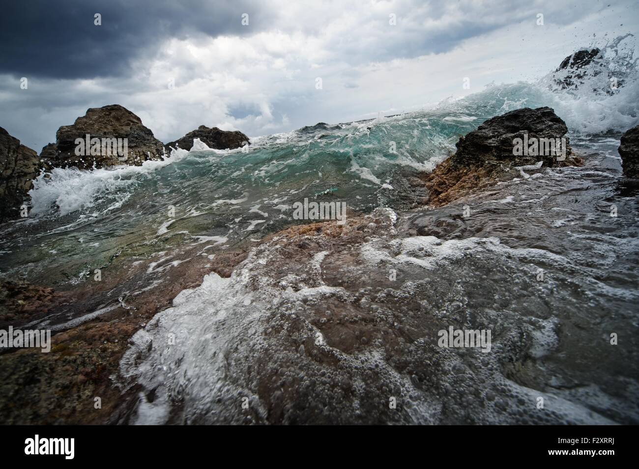 Big ocean wave breaking the rocks Stock Photo - Alamy