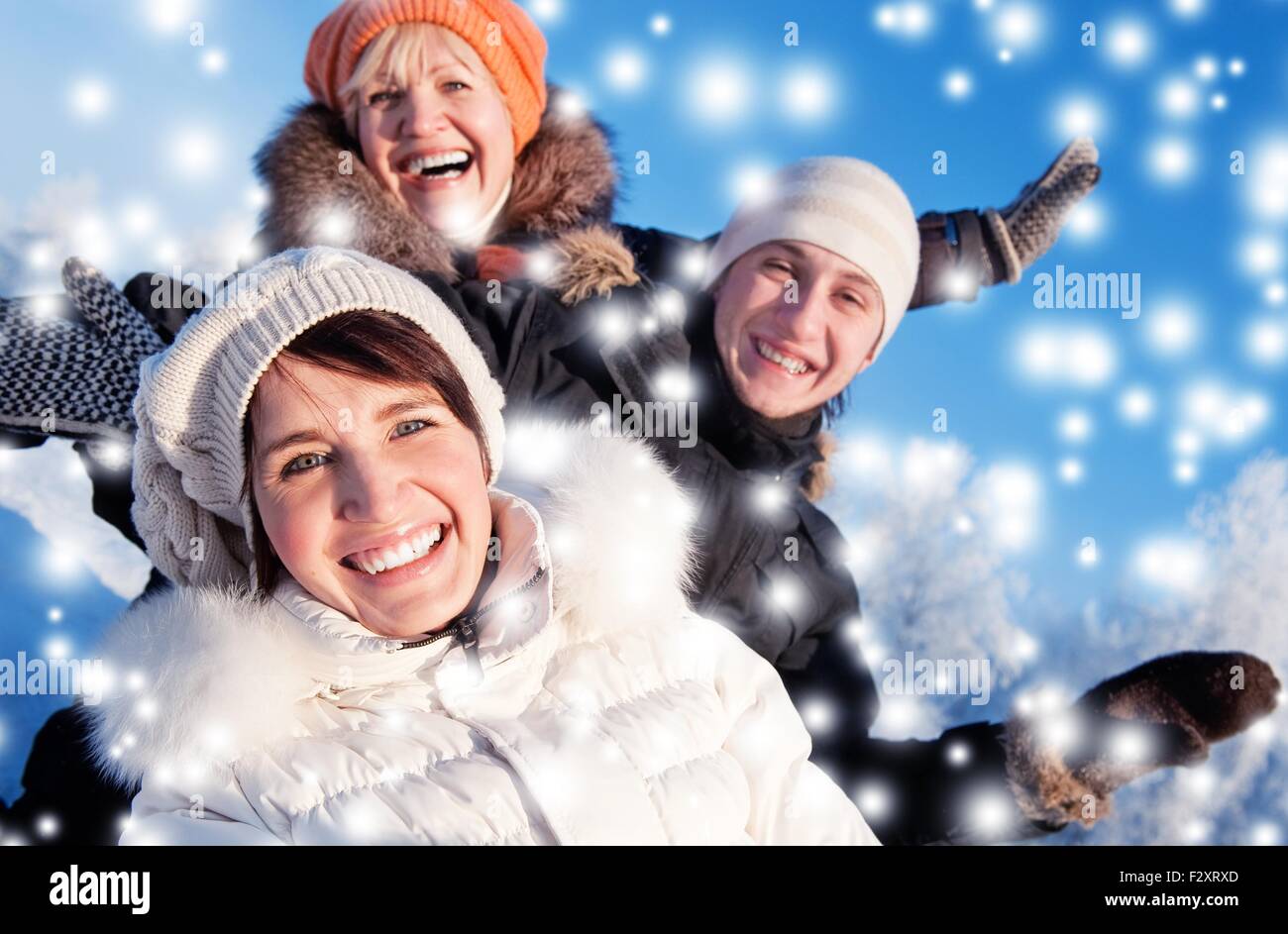 Happy friends on a winter background Stock Photo - Alamy
