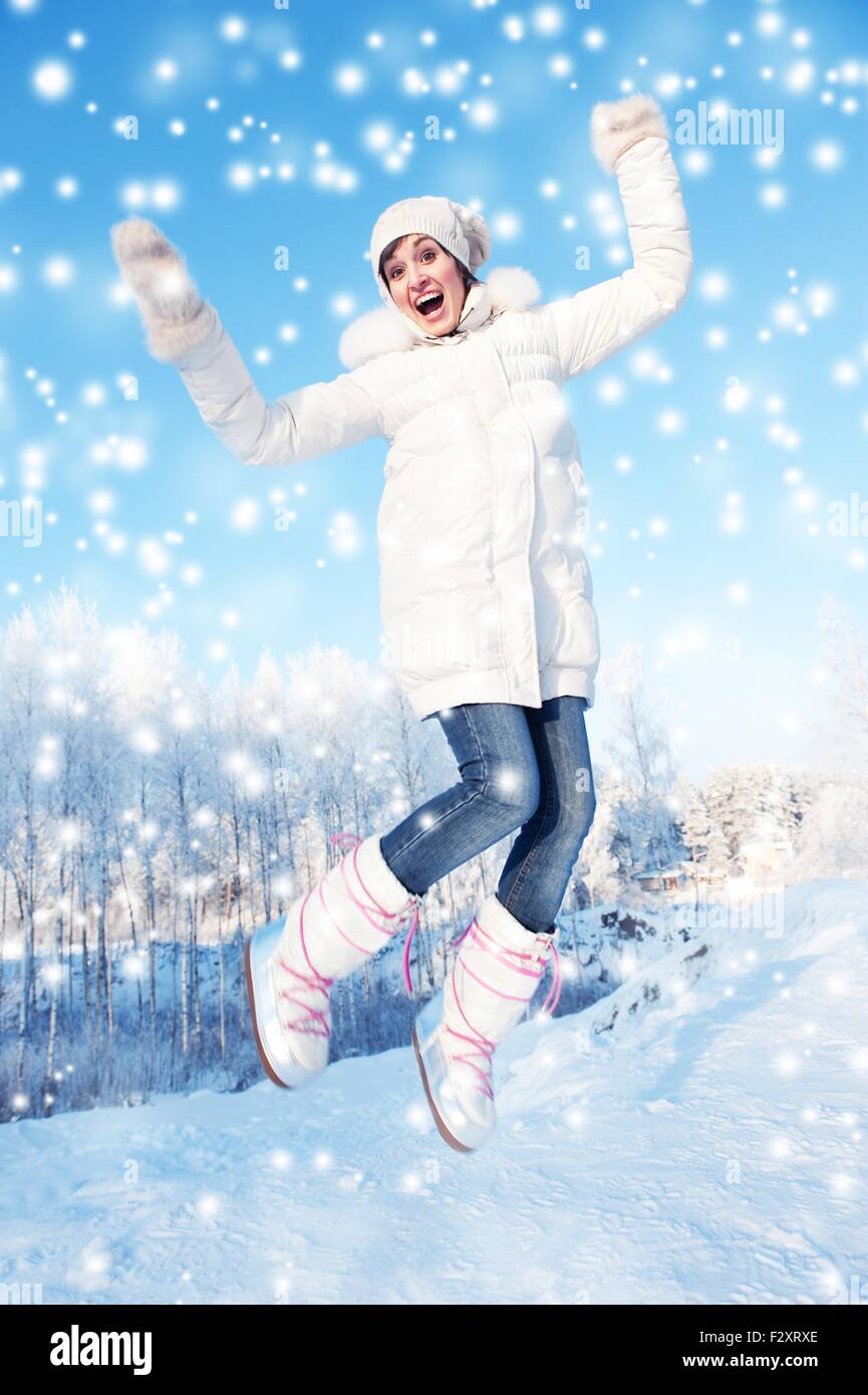 Happy girl jumping in the snow Stock Photo - Alamy