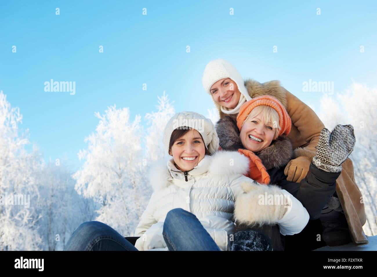 Happy friends on a winter background Stock Photo - Alamy