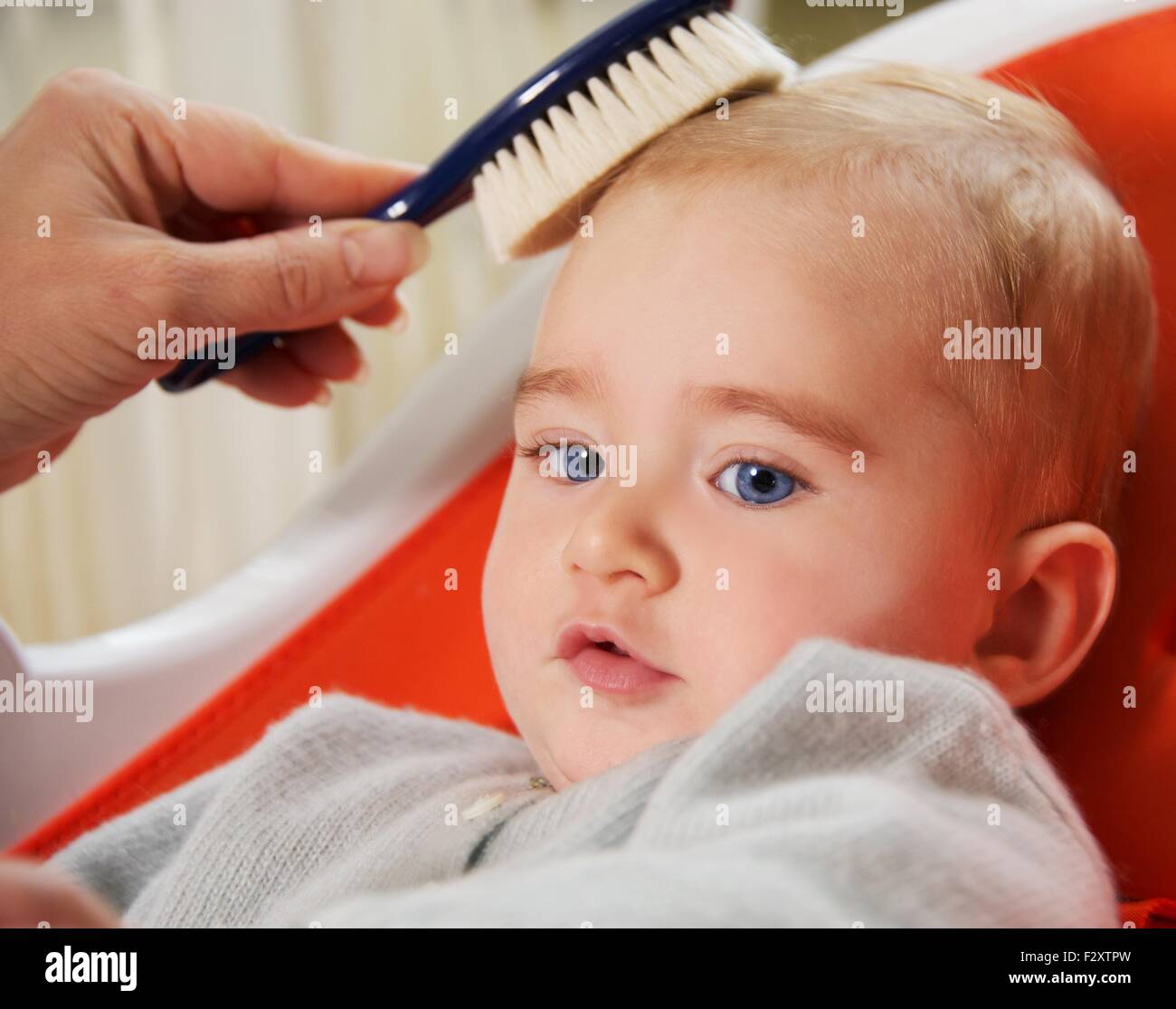 Mother combing her baby's hair Stock Photo - Alamy